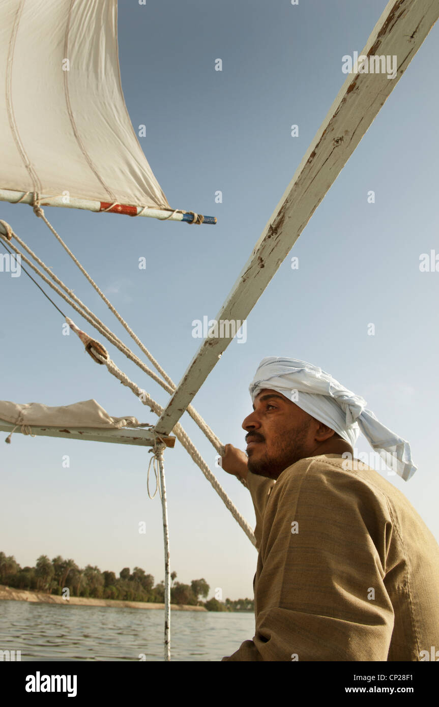 An Egyptian sailor sailing his Felucca on the River Nile in Luxor Stock ...