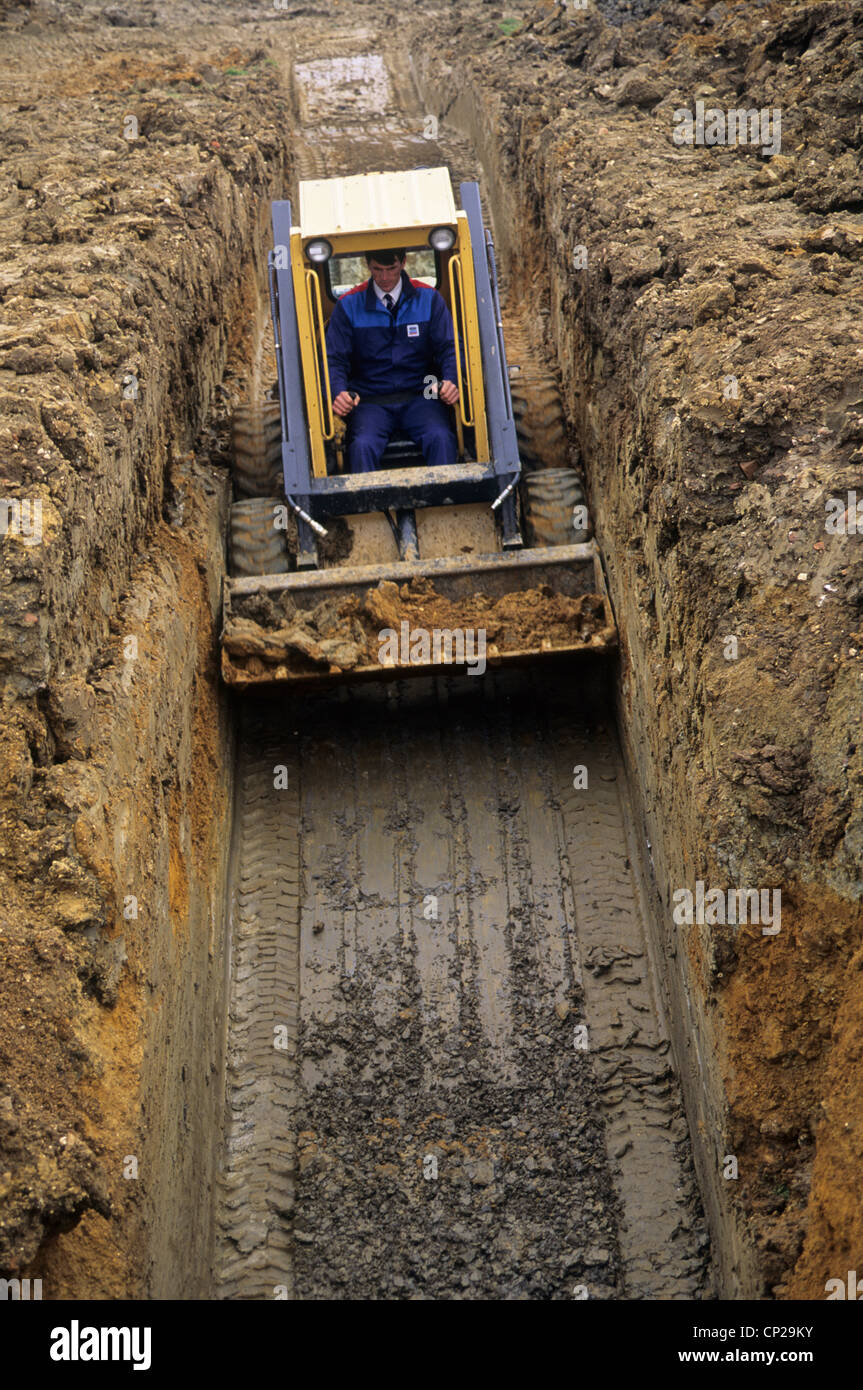 Industrial, man operating JCB on site Stock Photo - Alamy