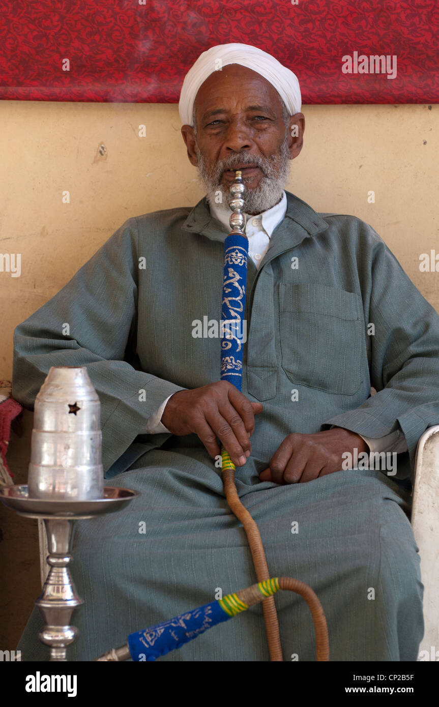 An Egyptian from Luxor smoking a chicha in the old market Stock Photo ...