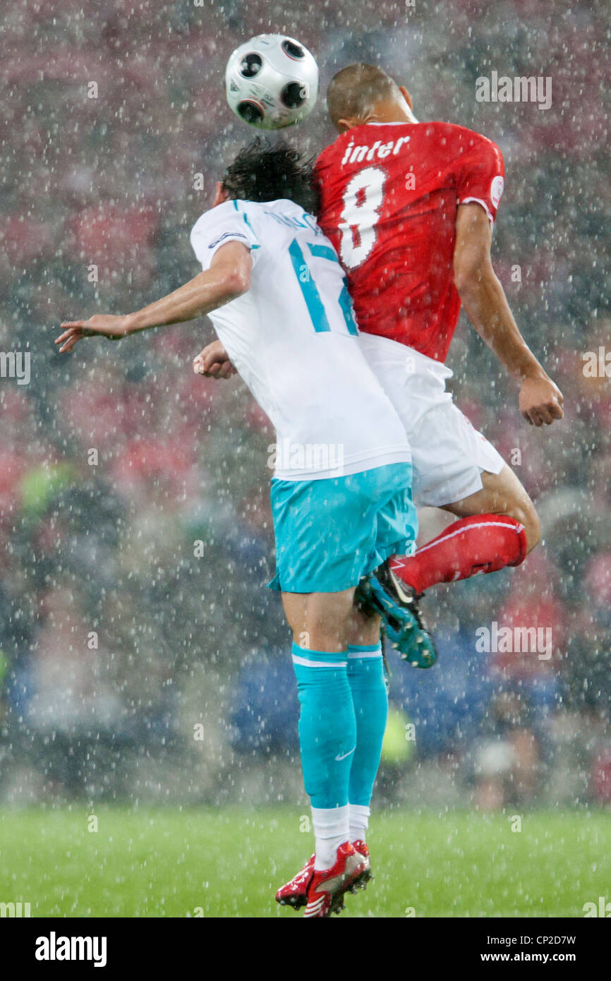 Tuncay Sanli of Turkey (L) and Gokhan Inler of Switzerland (R) battle ...