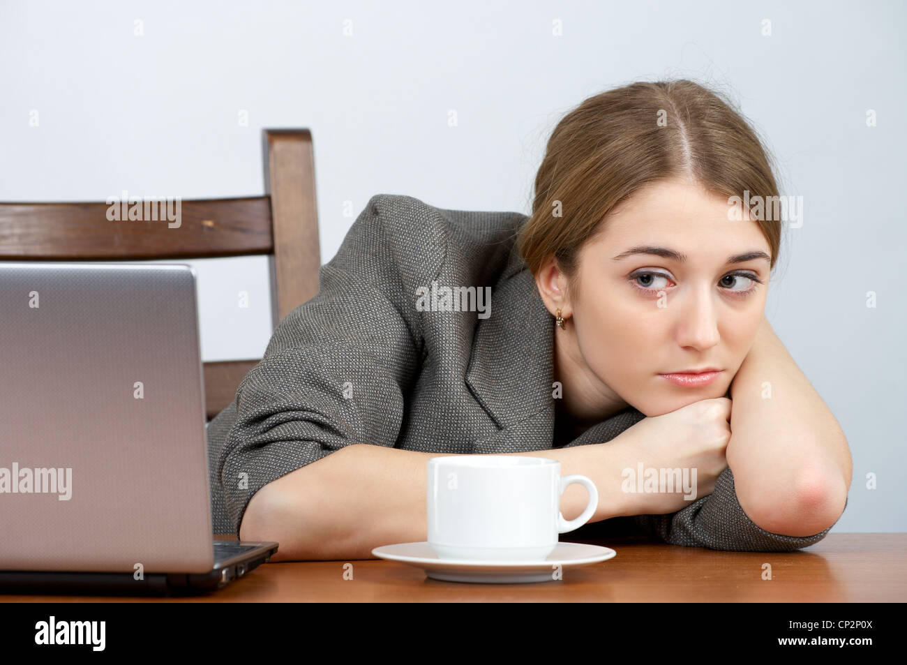 Portrait Of Tired Female Business Executive Looking At Laptop Screen