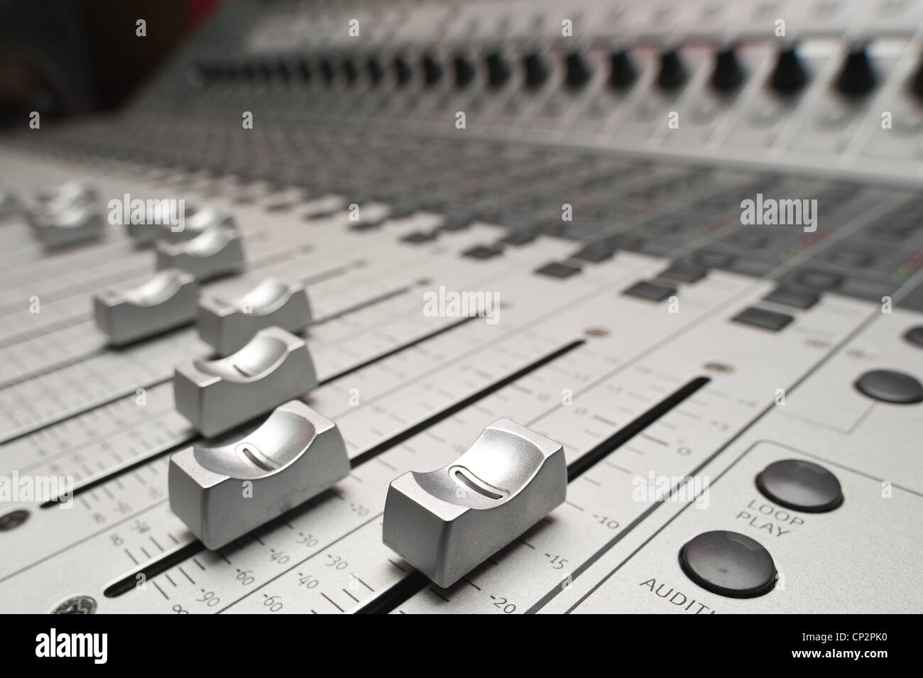 Electronic sound audio mixing desk console in recording studio showing ...