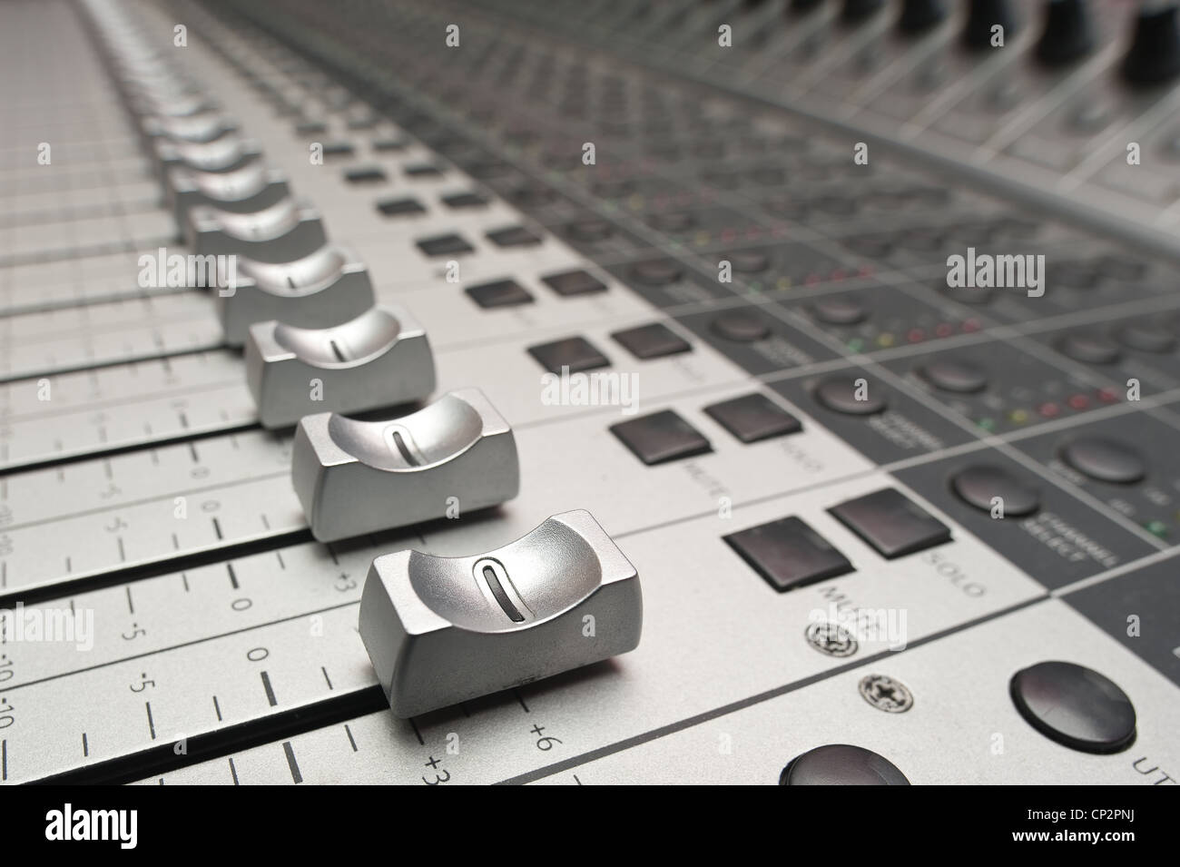 Electronic sound audio mixing desk console in recording studio showing ...
