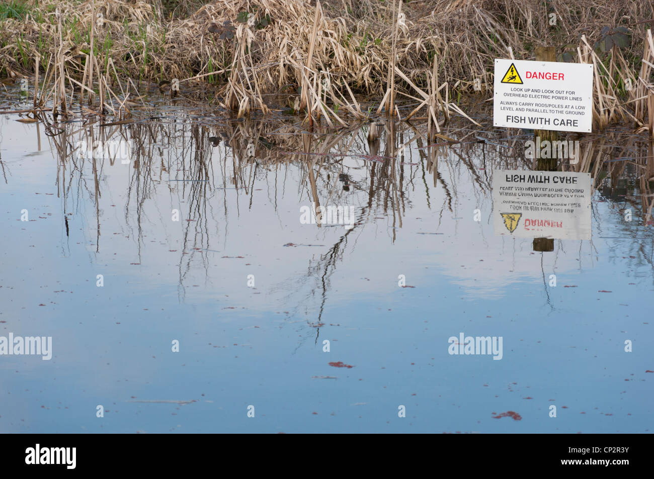 Canal surface with sign warning of submerged electrical cabling Stock ...
