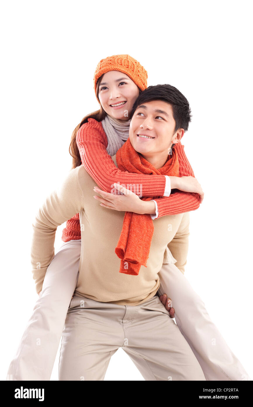 Smiling young couple doing piggyback Stock Photo - Alamy