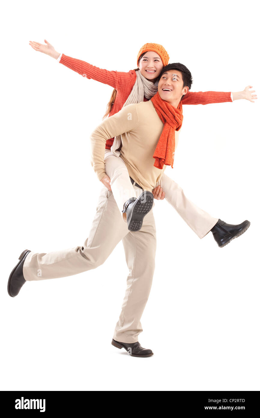 Smiling young couple doing piggyback Stock Photo - Alamy