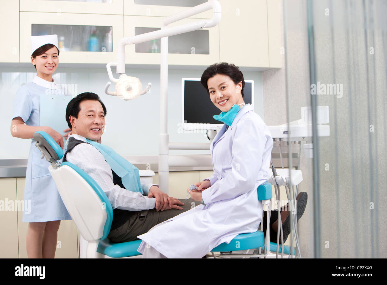 Patient receiving treatment in dental clinic Stock Photo - Alamy