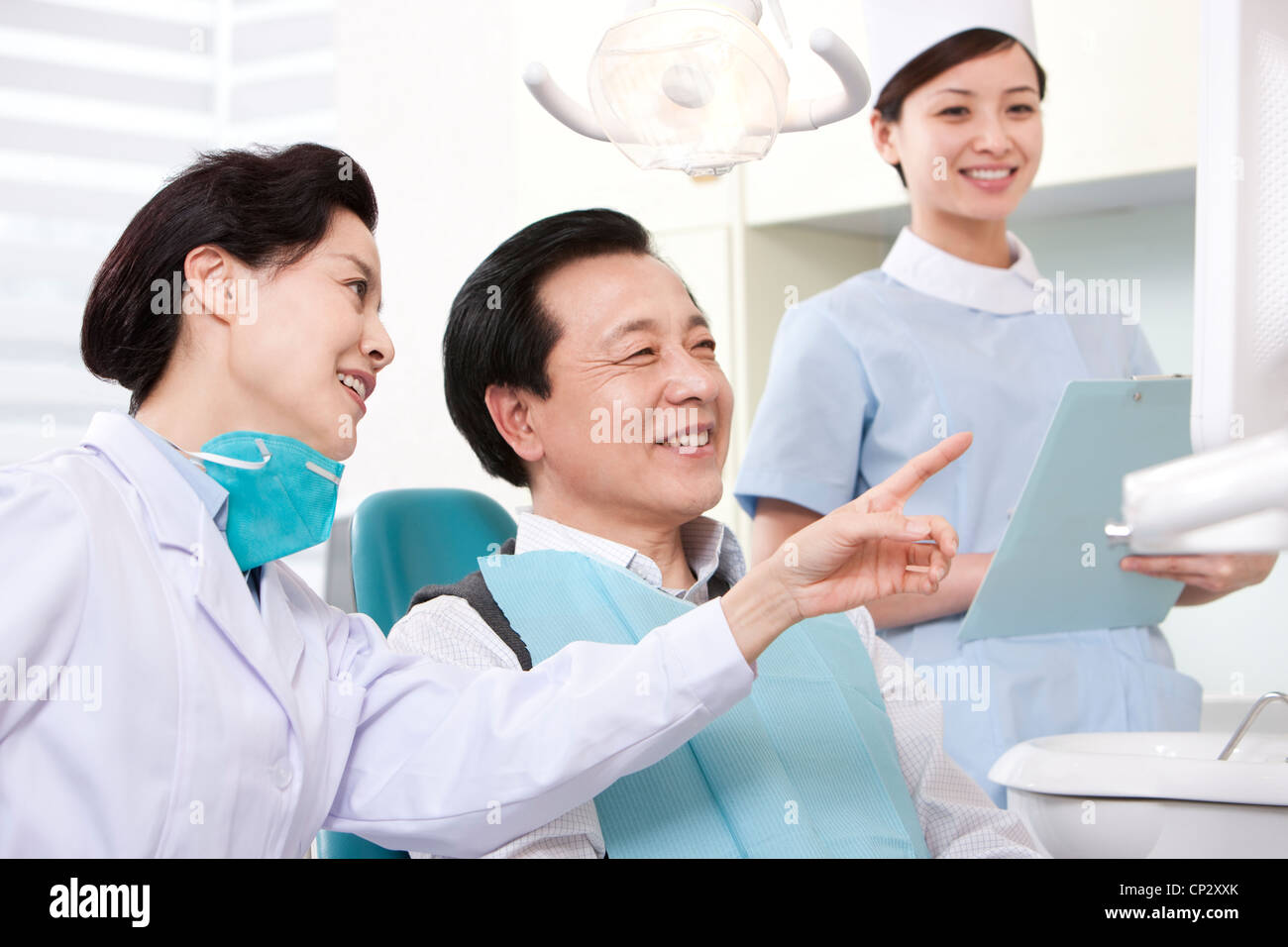 Patient receiving treatment in dental clinic Stock Photo - Alamy