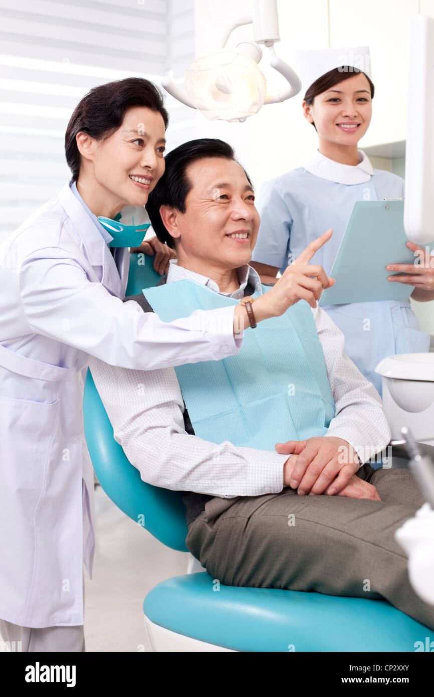 Patient receiving treatment in dental clinic Stock Photo - Alamy
