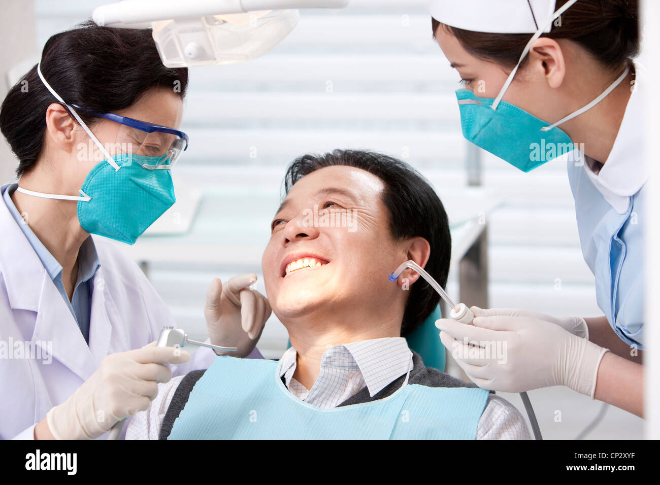 Patient receiving treatment in dental clinic Stock Photo - Alamy