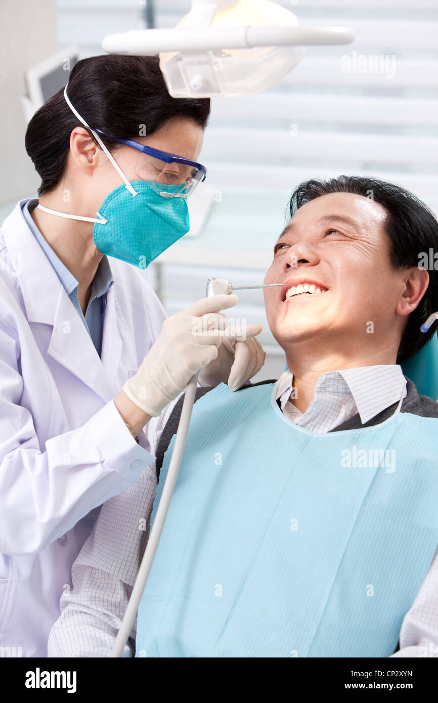 Patient receiving treatment in dental clinic Stock Photo - Alamy