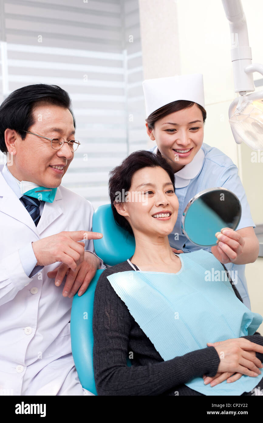 Patient receiving treatment in dental clinic Stock Photo - Alamy