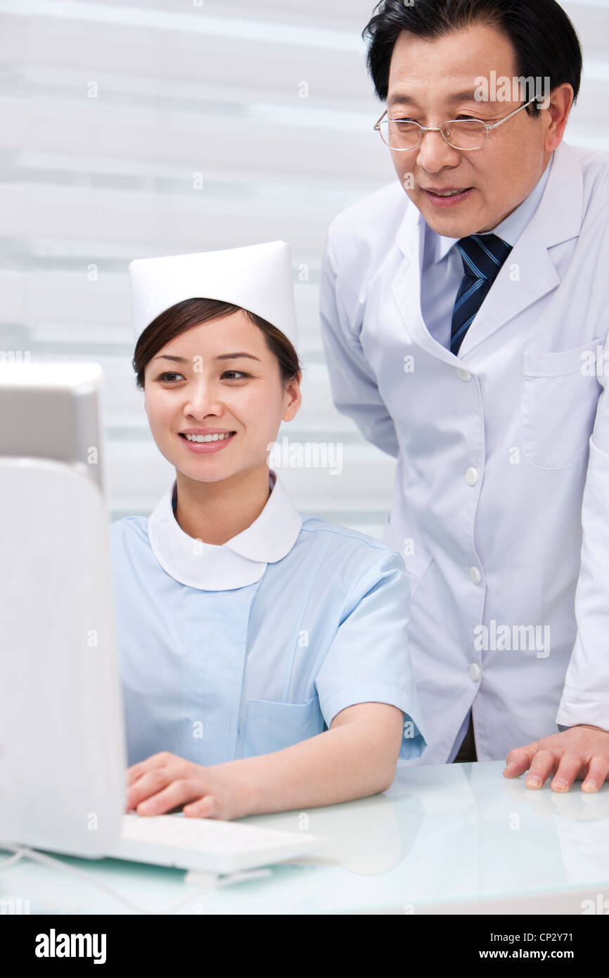 Doctor and nurse using computer in hospital Stock Photo - Alamy