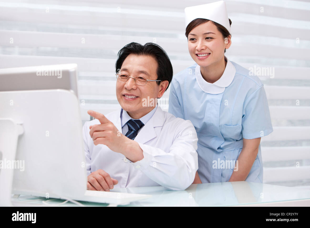Doctor and nurse using computer in hospital Stock Photo - Alamy