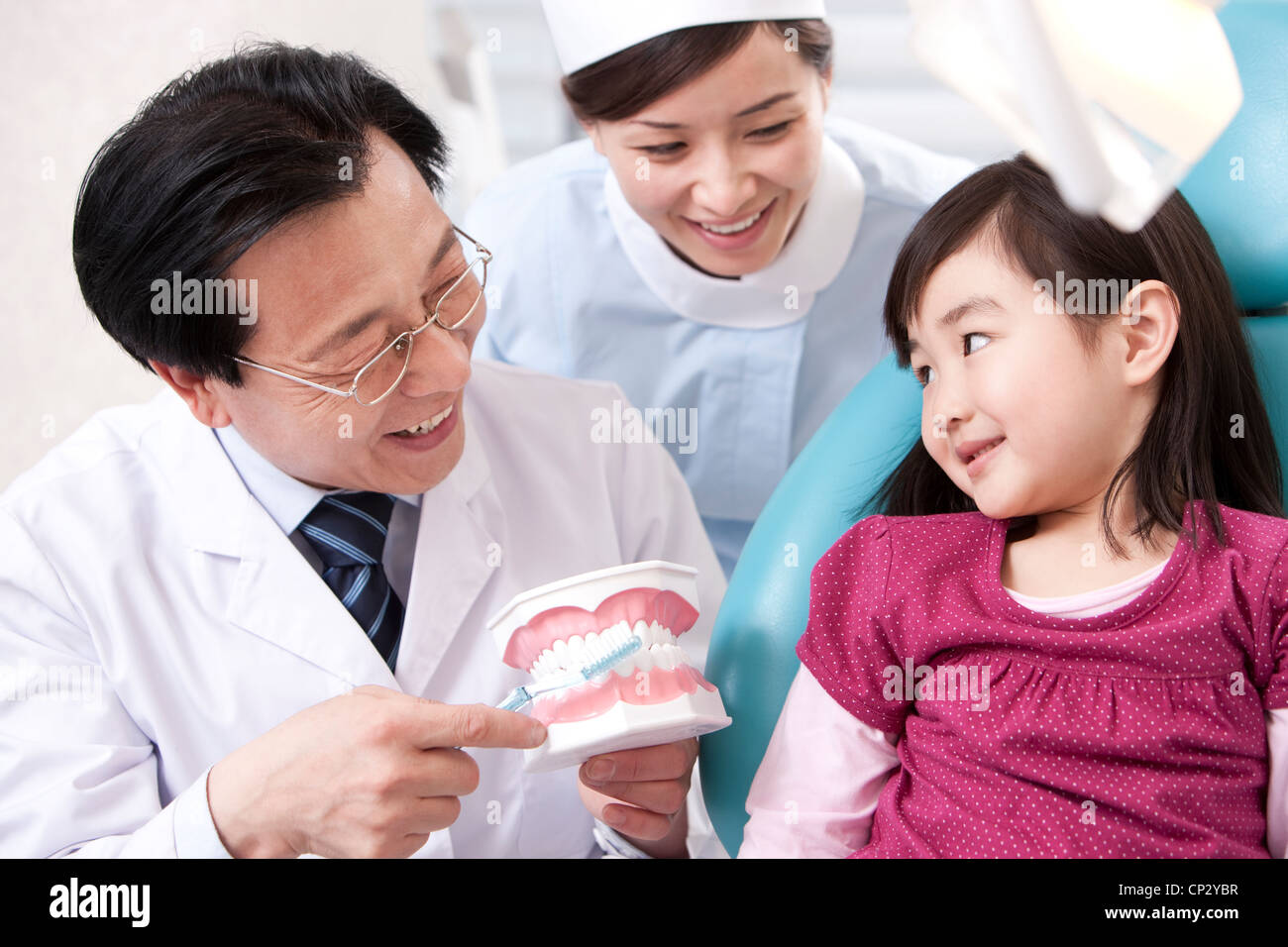 Dentist teaching the right way of brushing teeth Stock Photo - Alamy