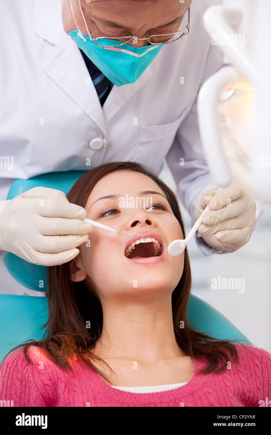 Patient receiving treatment in dental clinic Stock Photo - Alamy