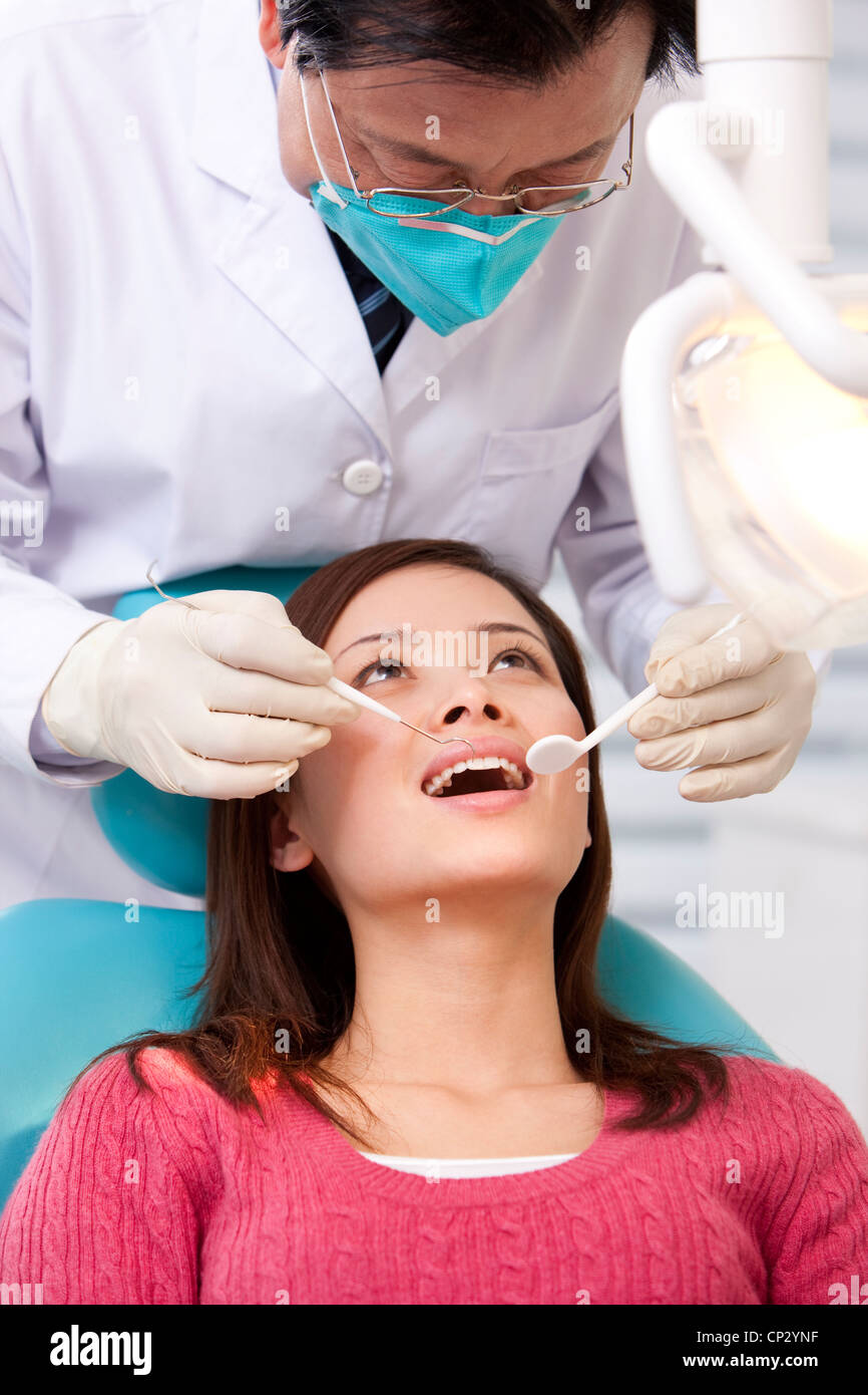 Patient receiving treatment in dental clinic Stock Photo - Alamy