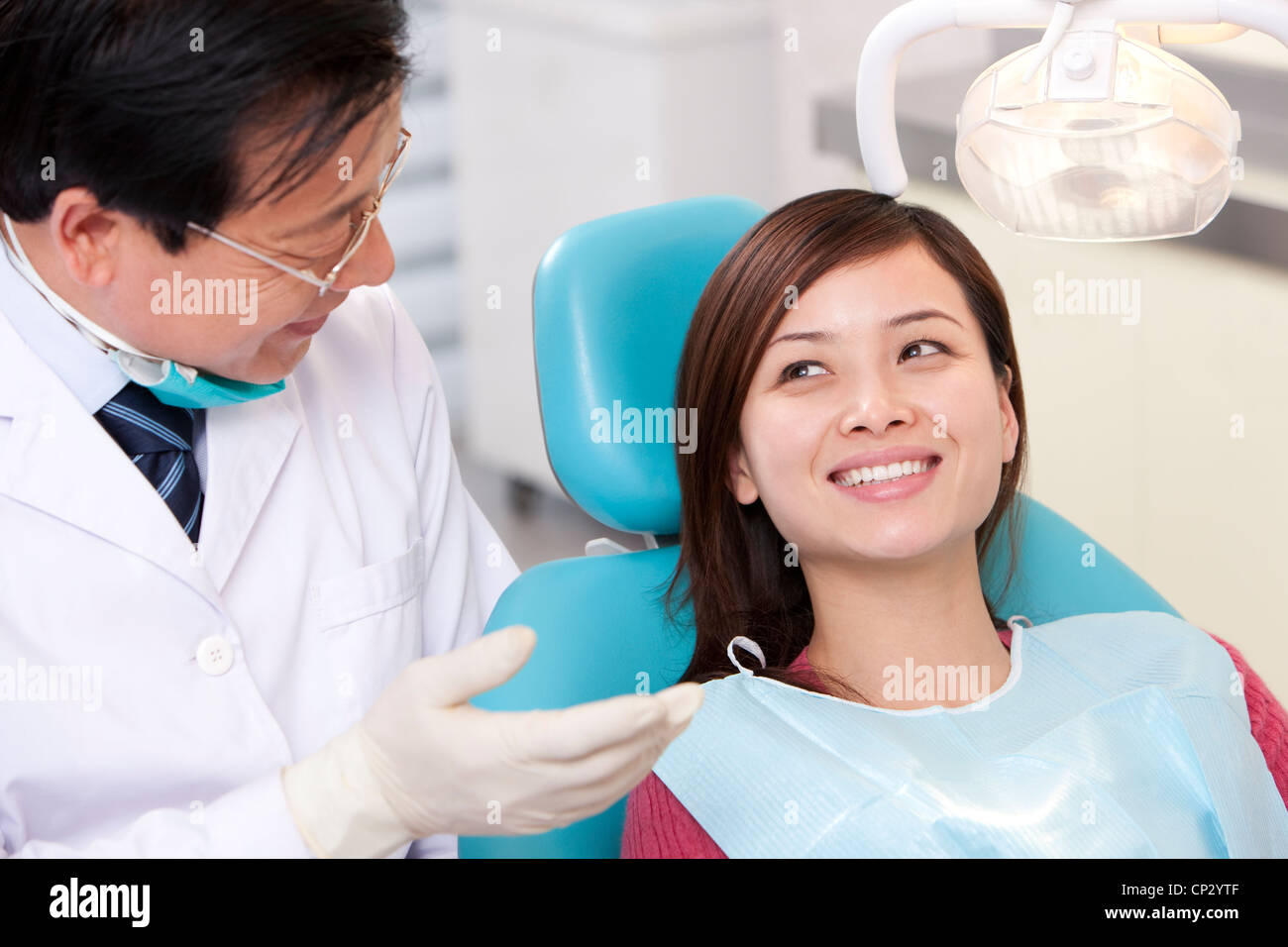 Patient receiving treatment in dental clinic Stock Photo - Alamy