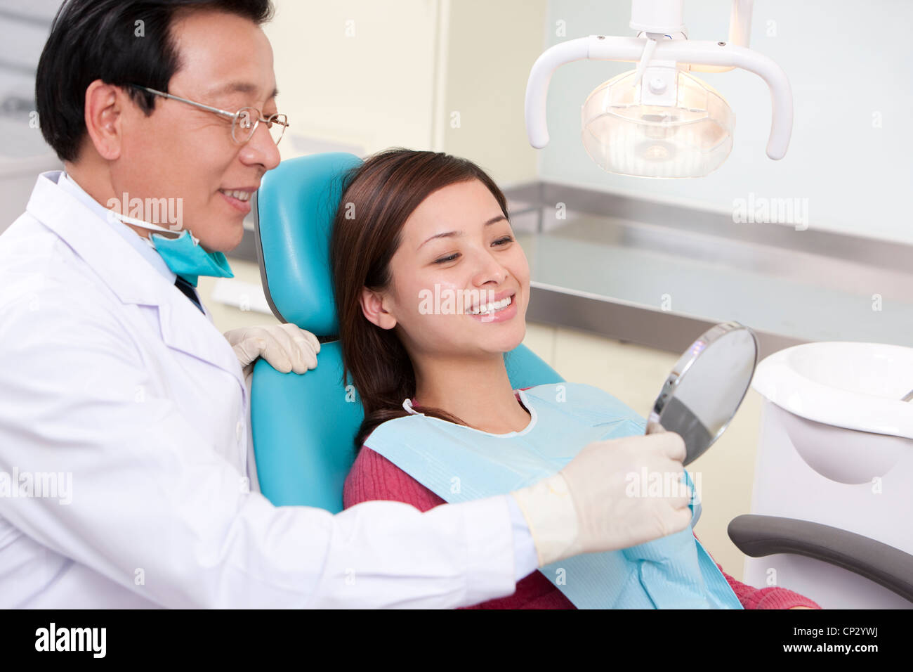 Patient receiving treatment in dental clinic Stock Photo - Alamy
