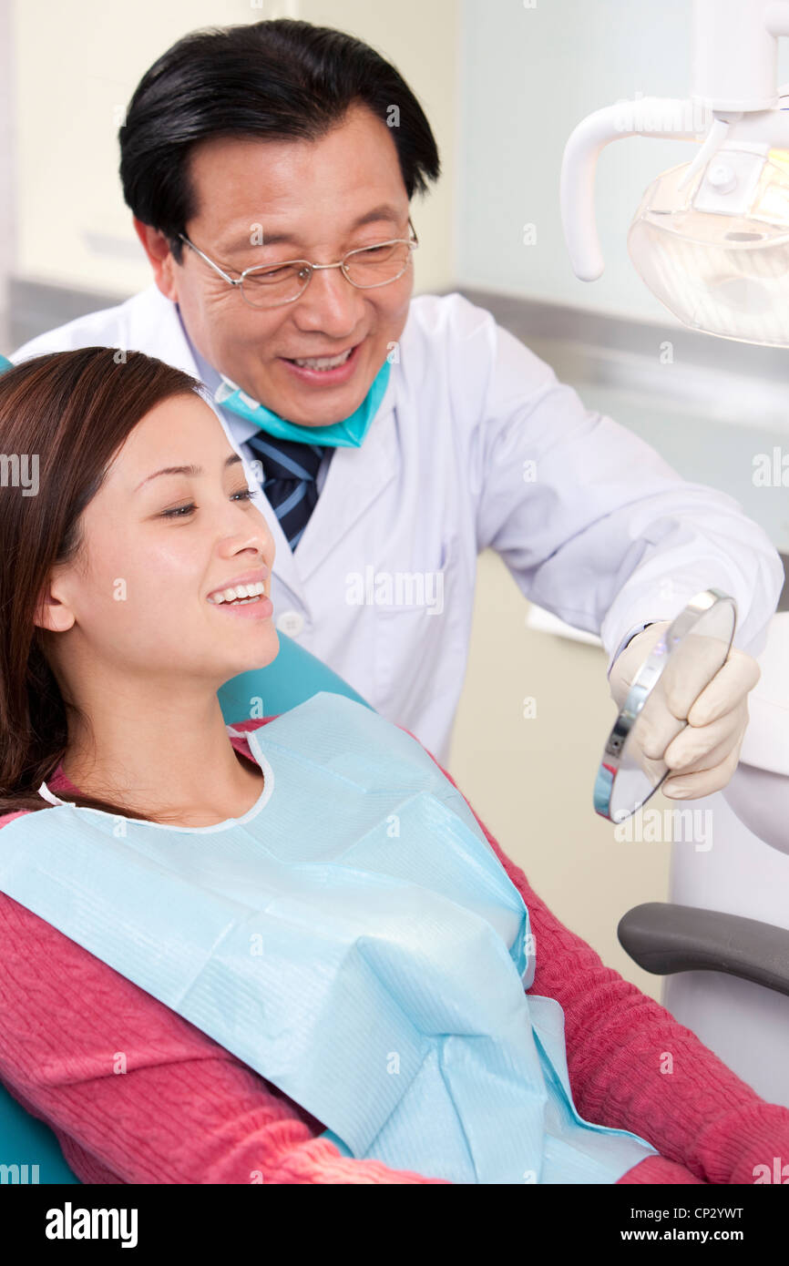 Patient receiving treatment in dental clinic Stock Photo - Alamy