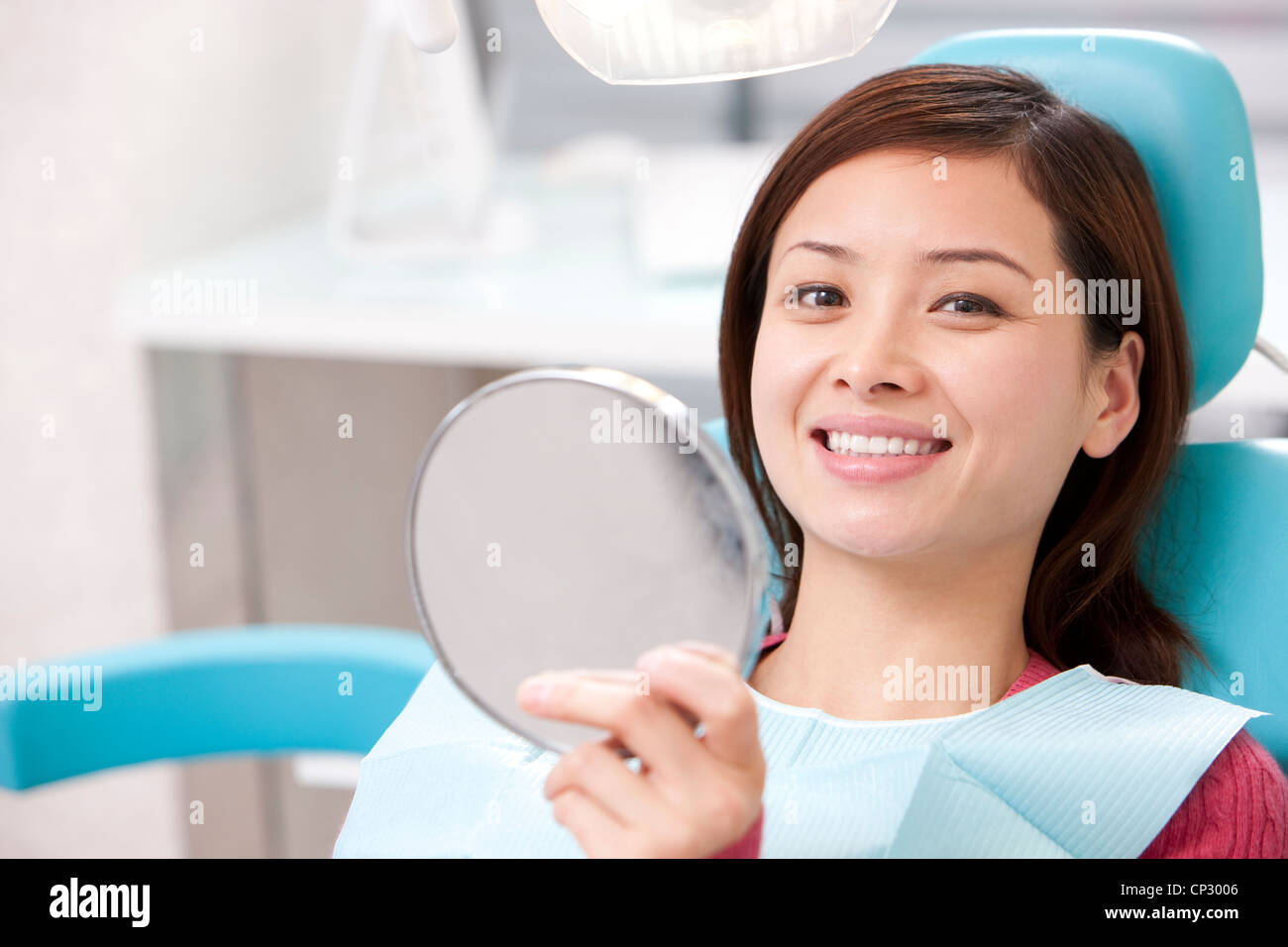 Patient examining teeth in mirror Stock Photo - Alamy