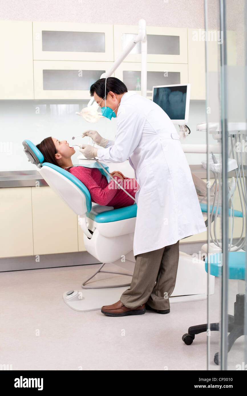 Patient receiving treatment in dental clinic Stock Photo - Alamy