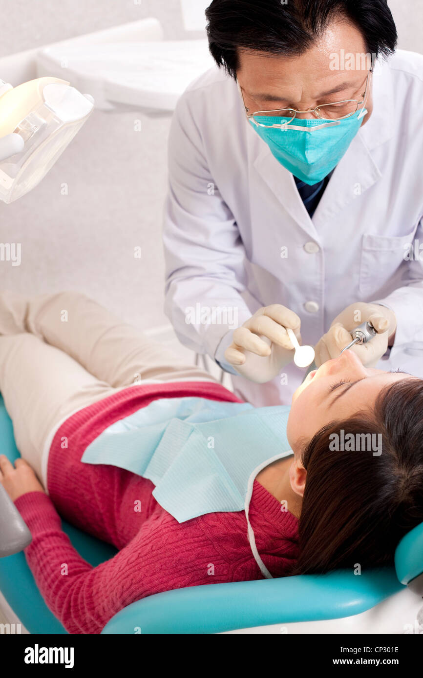 Patient receiving treatment in dental clinic Stock Photo - Alamy