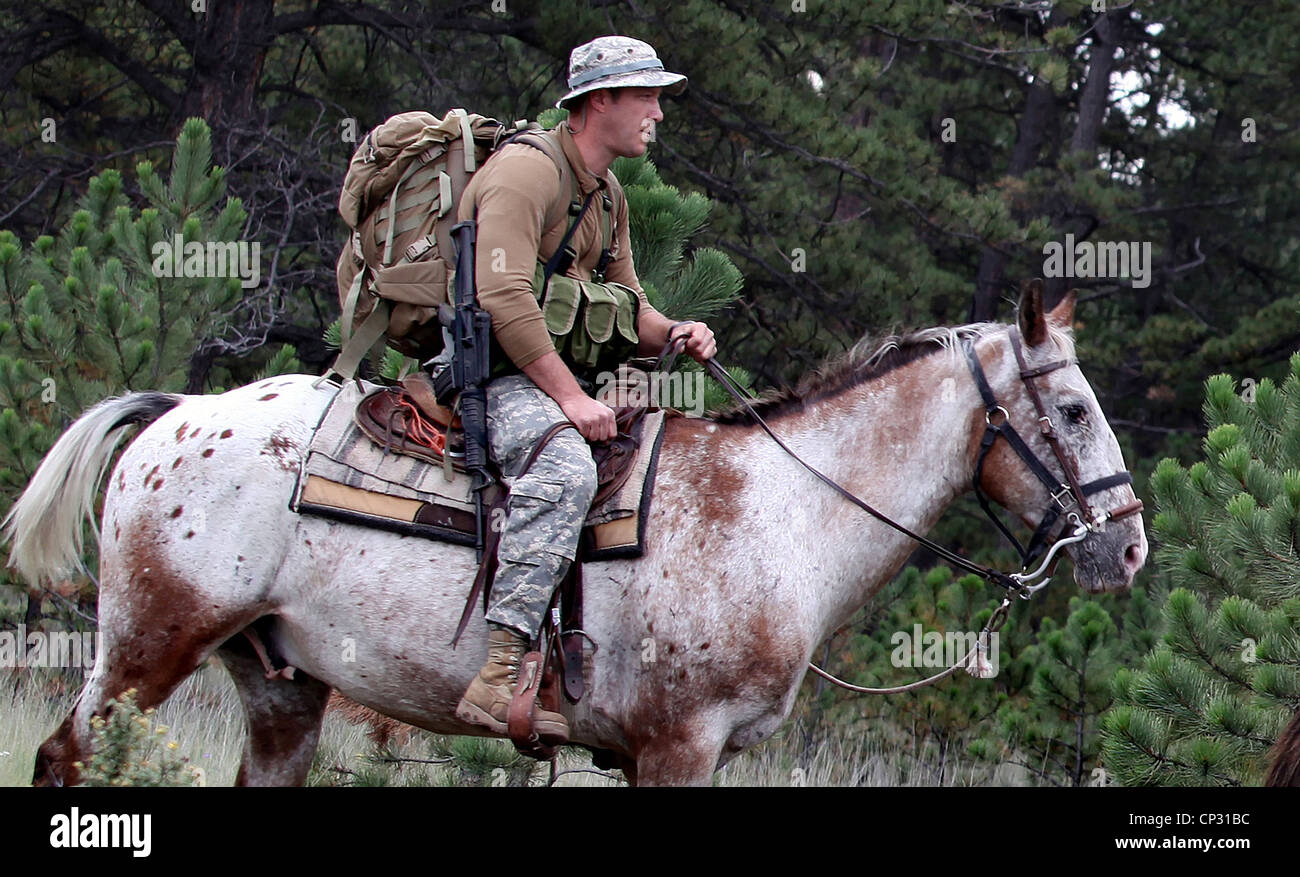 A US Army special operations soldier rides a horse during ...