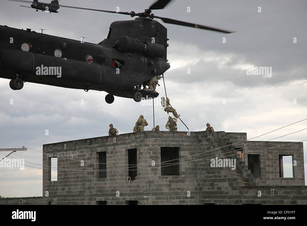 US Special Operations Forces fast rope from a Chinook helicopter during ...