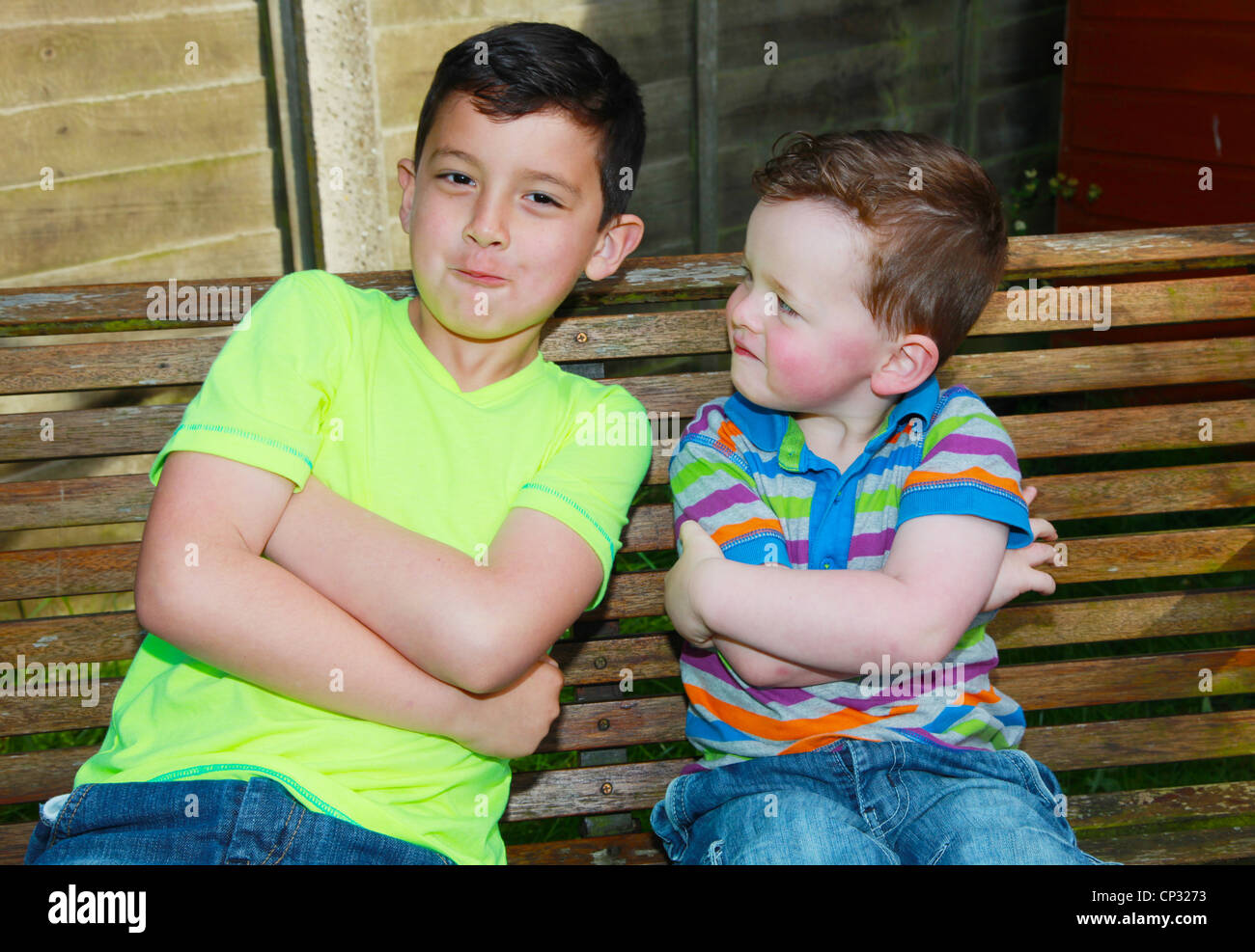 Two ethnic boys sitting bench hi-res stock photography and images - Alamy