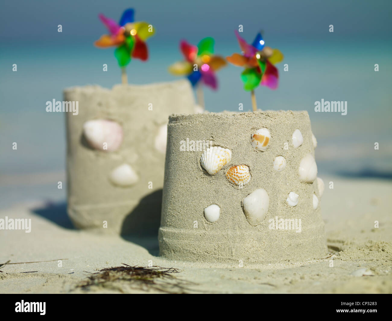 sand castles covered in shells on a beach Stock Photo - Alamy