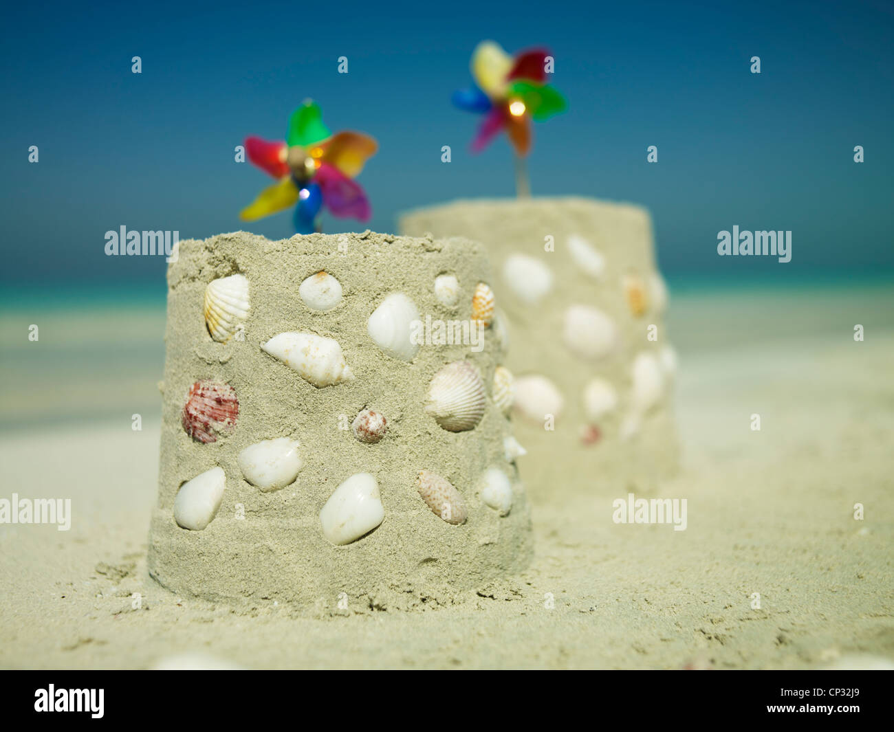 sand castles covered in shells on a beach Stock Photo - Alamy