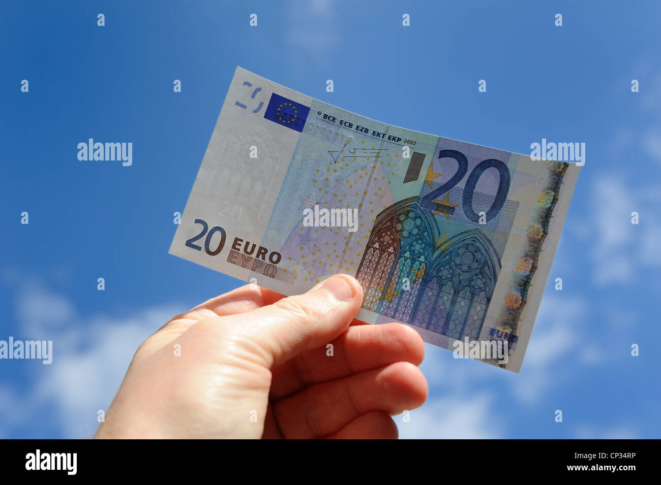 20 euro note being held against a blue sky Stock Photo - Alamy