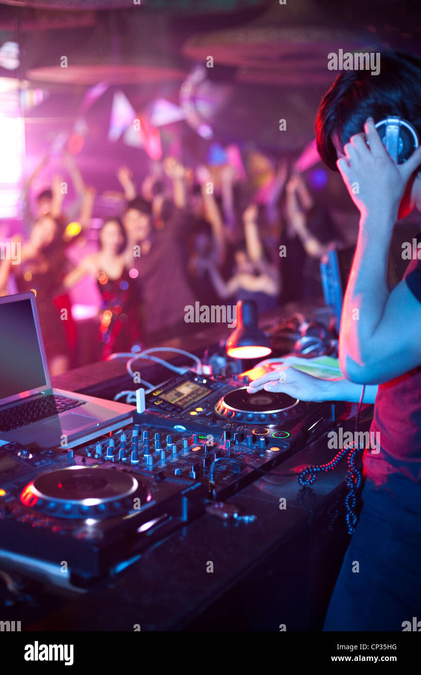 DJ doing record Scratching in nightclub Stock Photo - Alamy