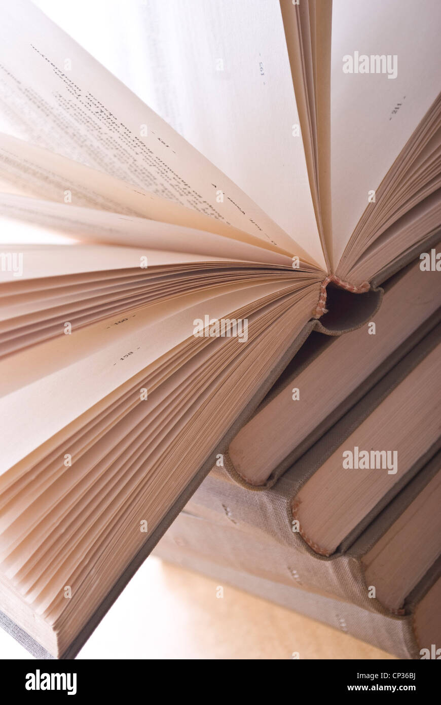 Open book on top of pile Stock Photo - Alamy