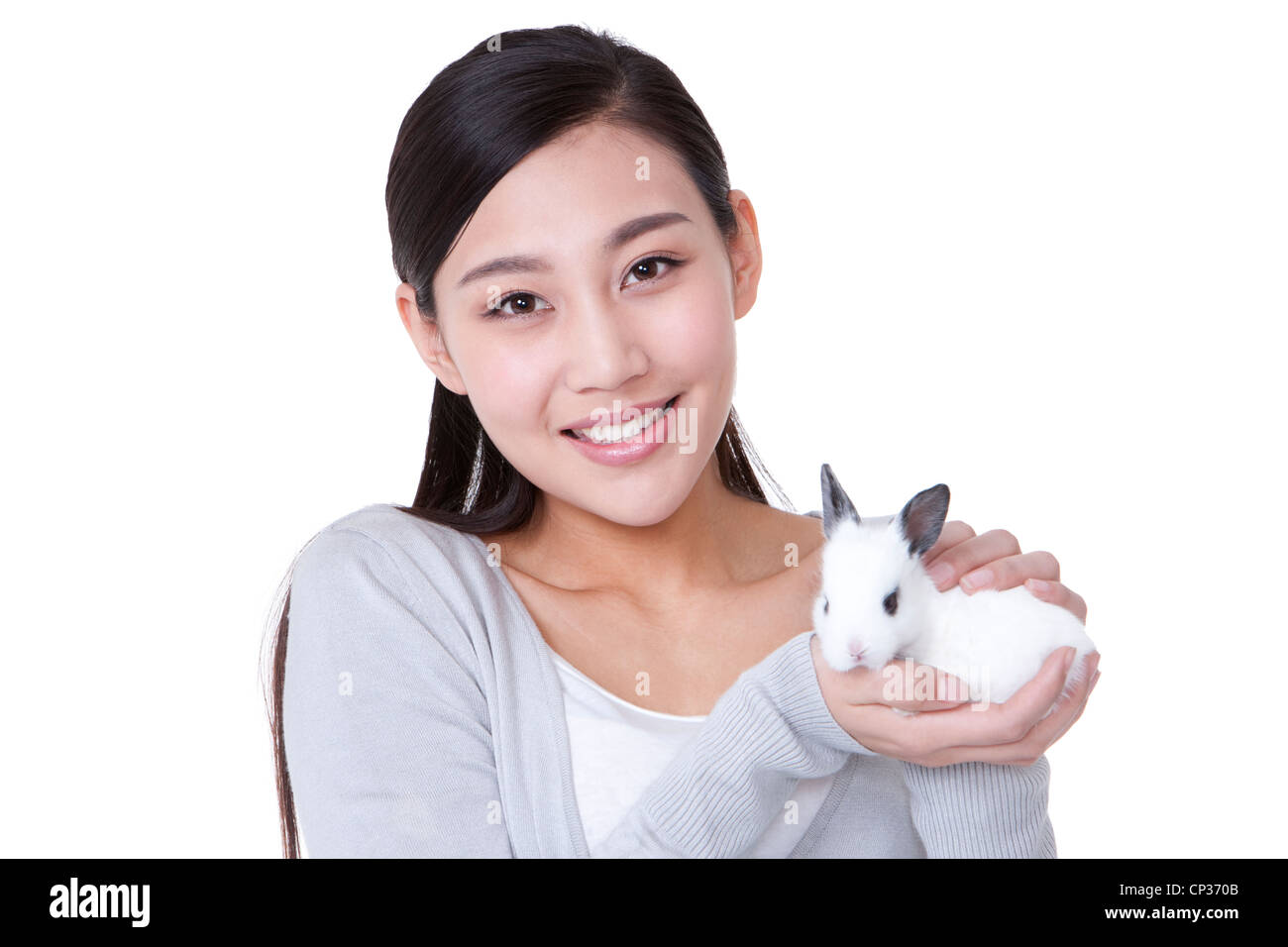 Young woman playing with rabbit Stock Photo - Alamy