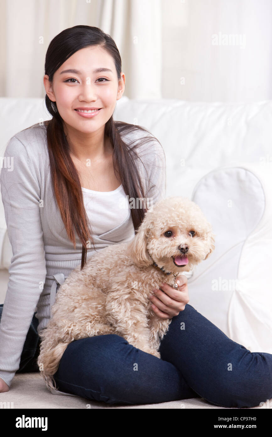 Family playing with a pet toy poodle Stock Photo - Alamy