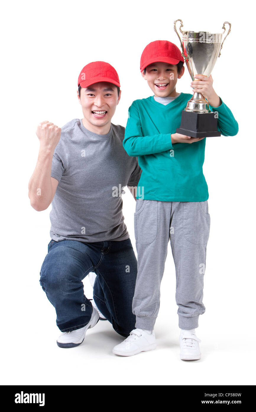 Father son holding trophy Cut Out Stock Images & Pictures - Alamy