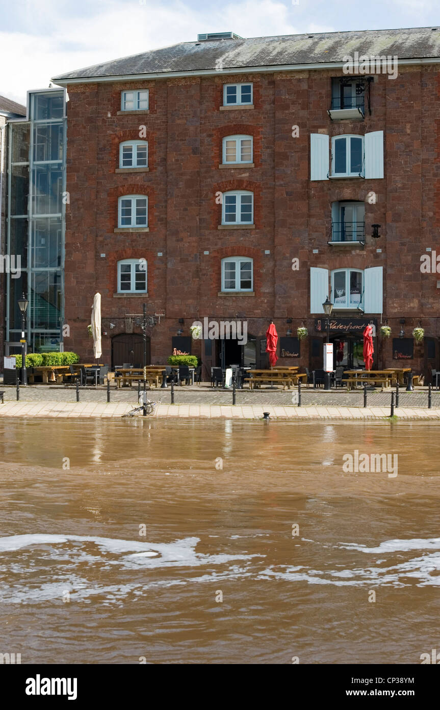 The River Exe overflowing into Exeter's flood relief and breaking the ...