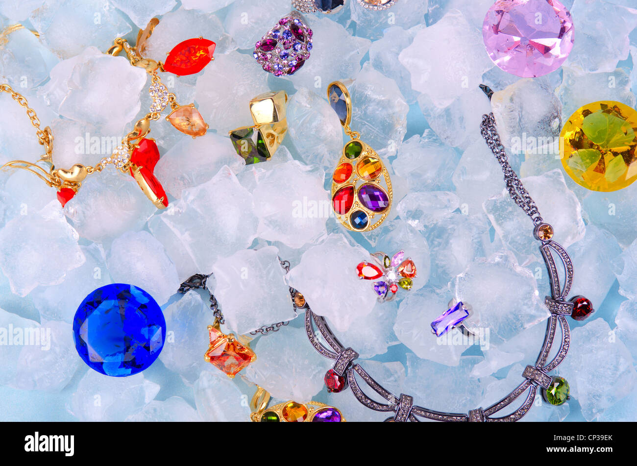 Jewels at blue cube of ice background Stock Photo - Alamy