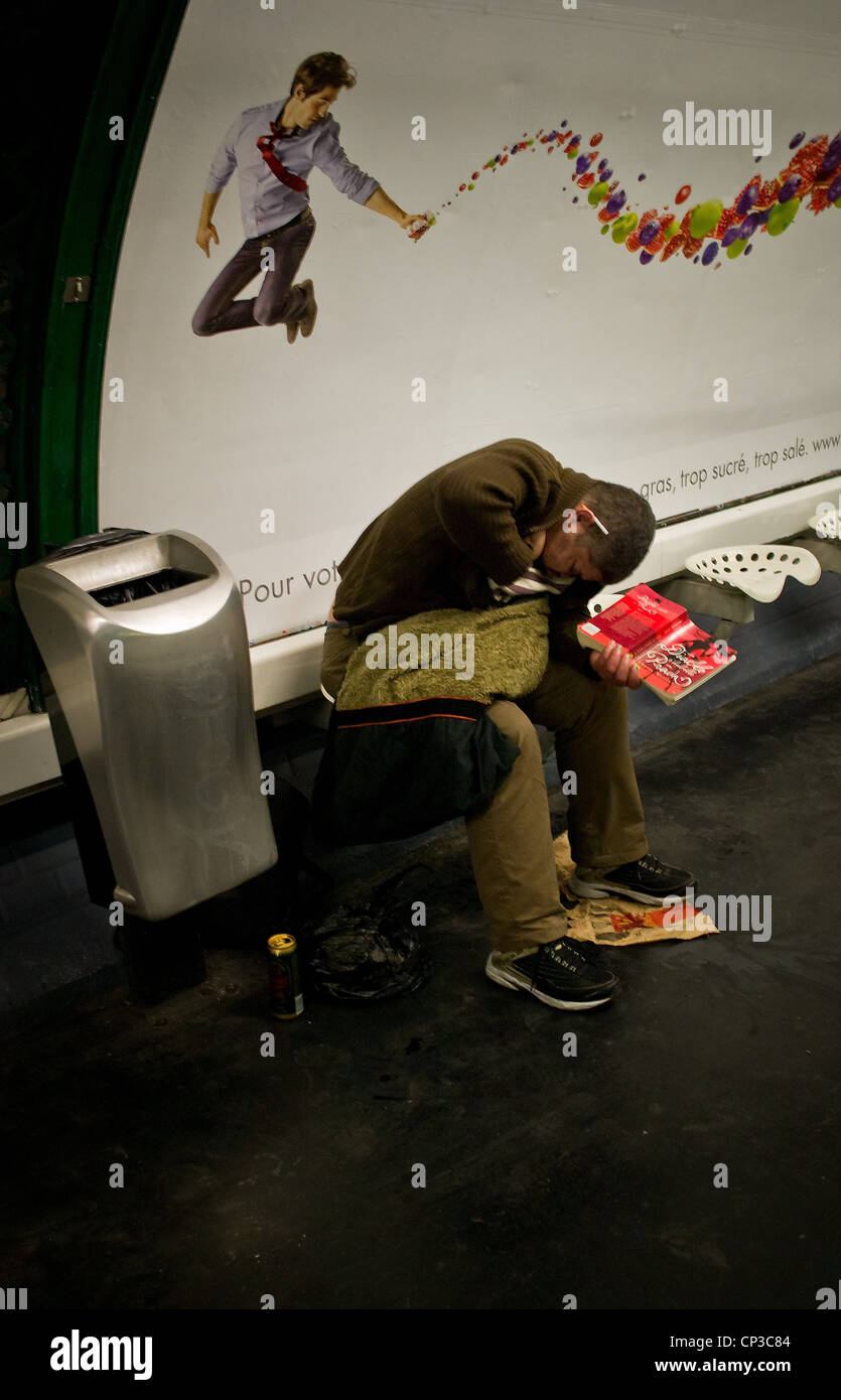 Urban poverty, Homeless in the Paris Metro, reading the devil wears ...