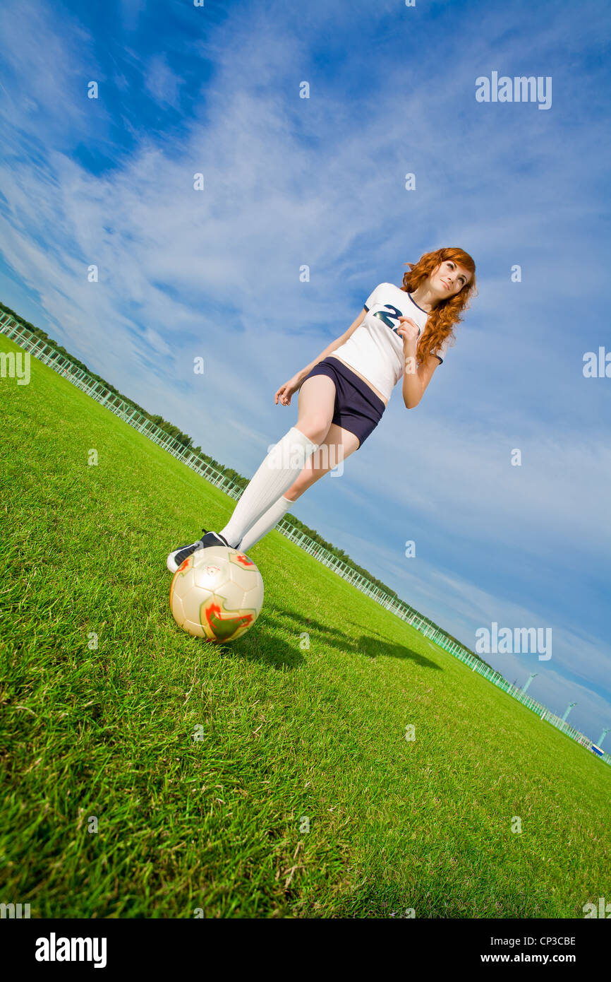 Beautiful redhead girl plays soccer Stock Photo - Alamy