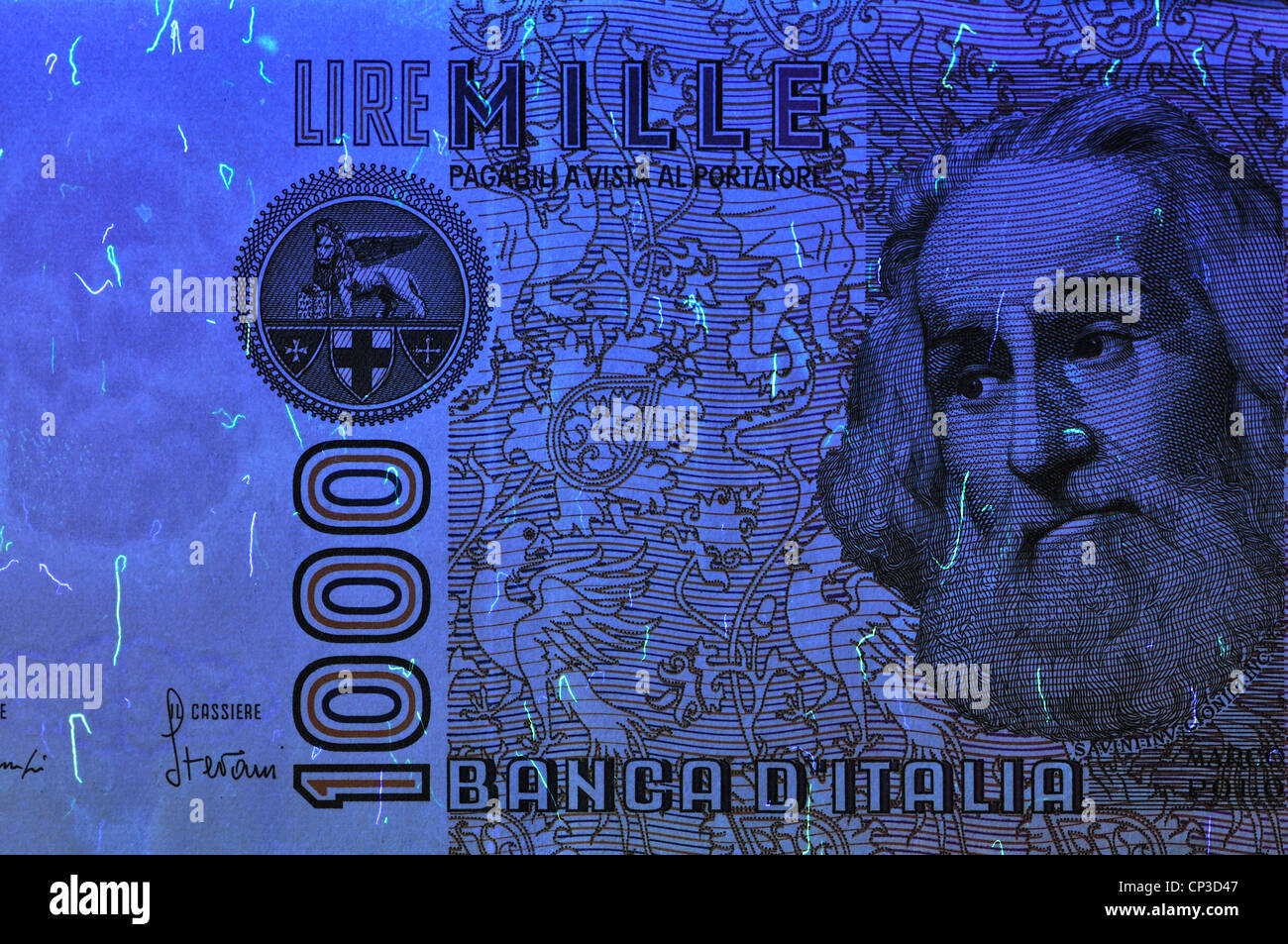 Banknote under ultraviolet light showing security features invisible in ...