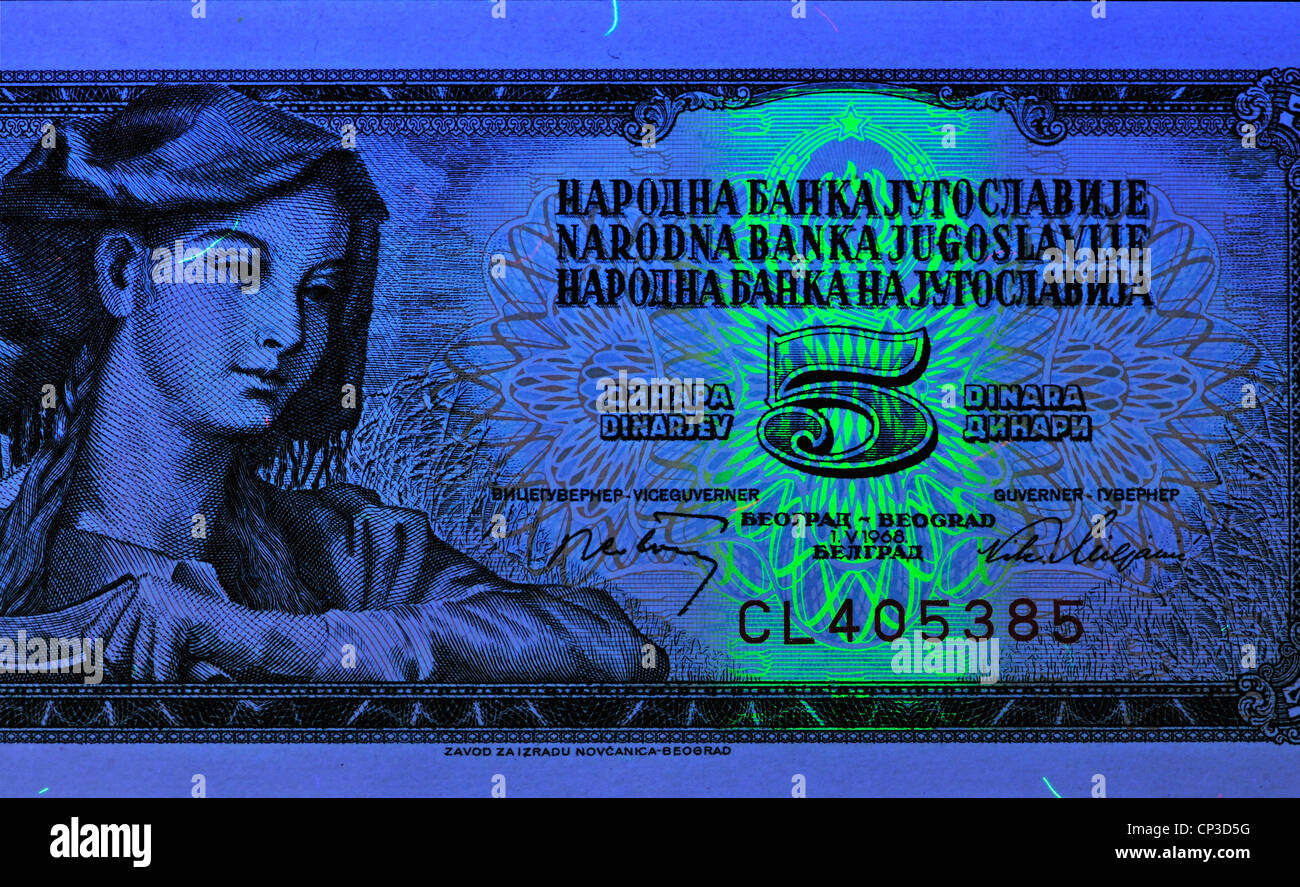 Banknote under ultraviolet light showing security features invisible in ...