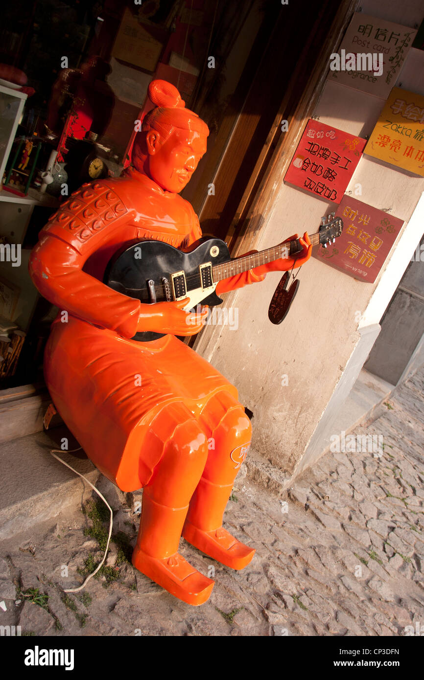 Orange 'God' with guitar, Suzhou, China Stock Photo - Alamy