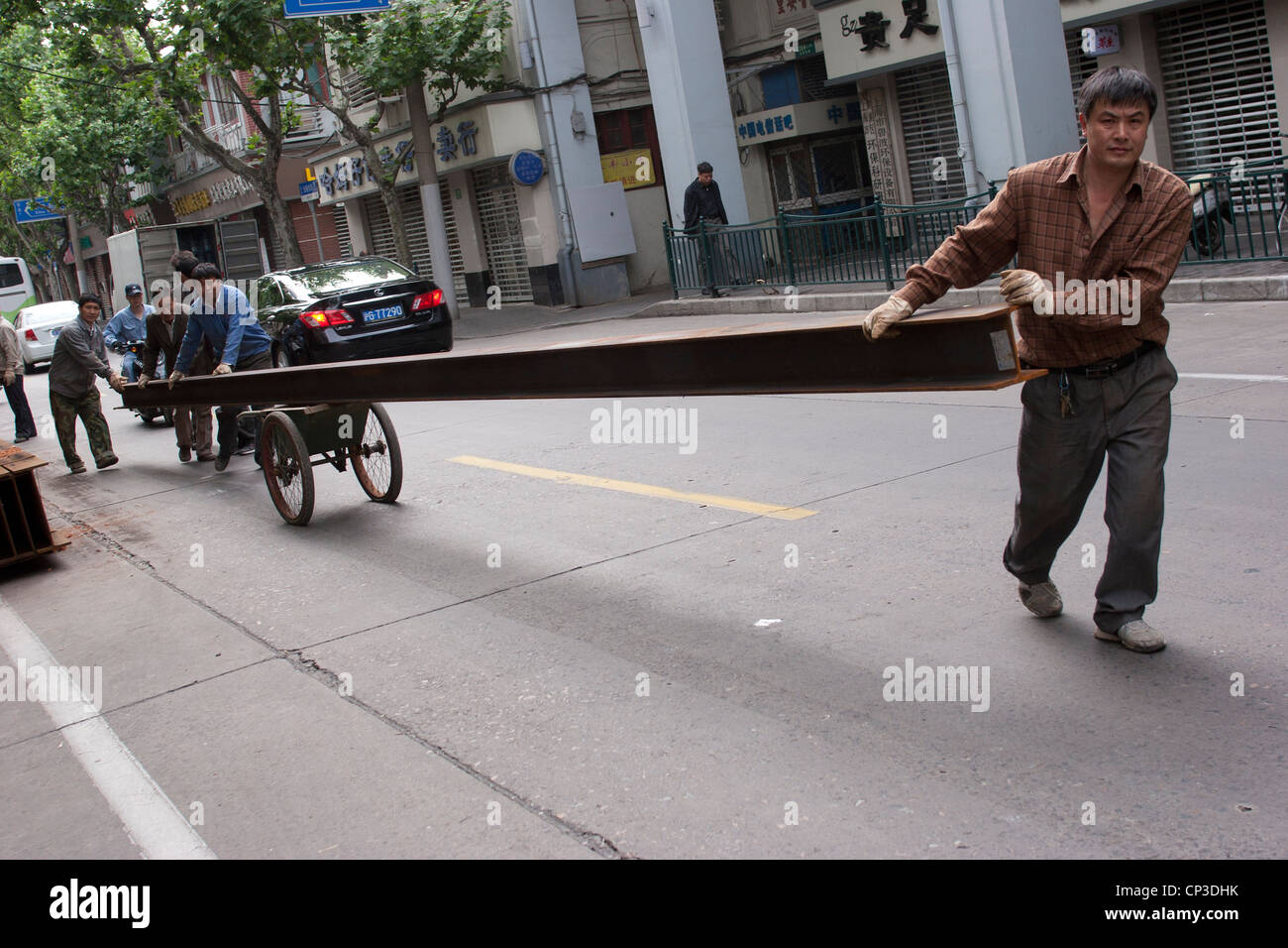 Moving a girder in the street, on wheels, for building construction ...