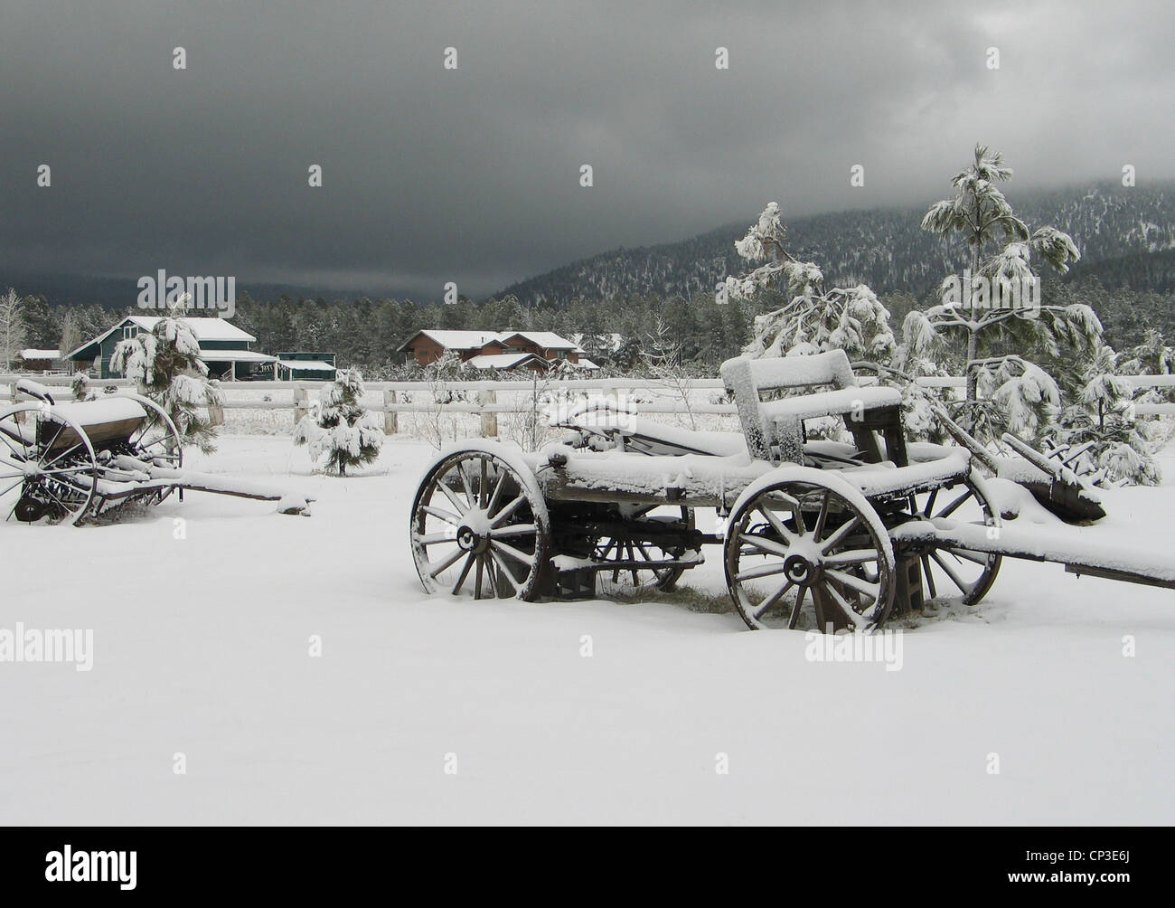 An old buckboard wagon is covered in snow just after a snowstorm in ...
