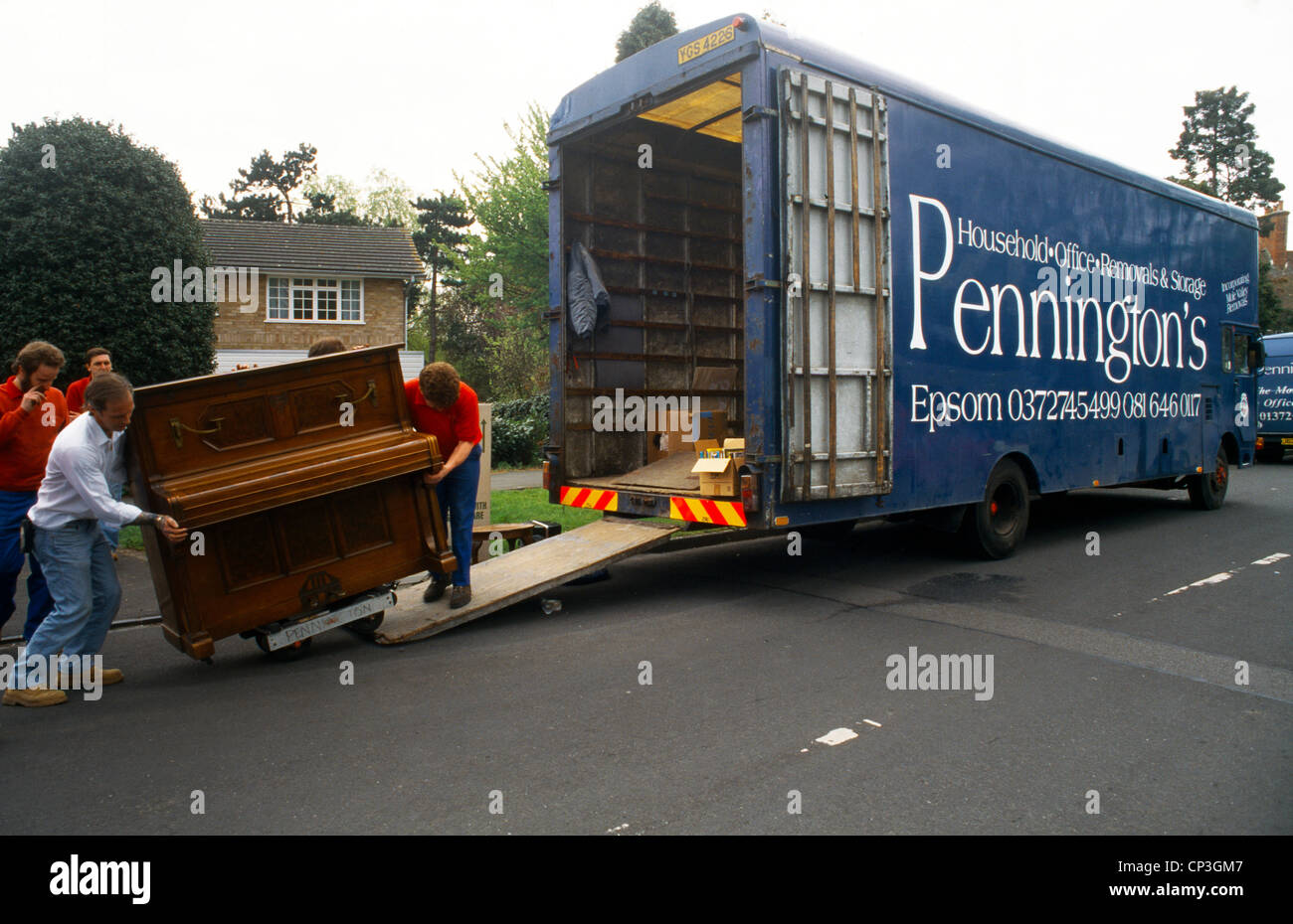 House Removal Men Loading Piano into Van Stock Photo - Alamy