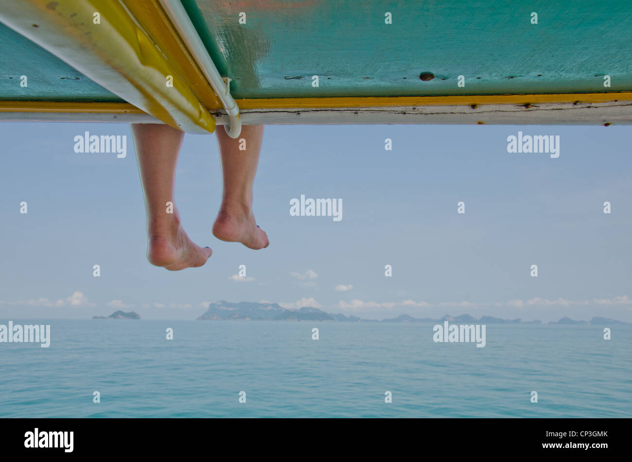 Legs of woman sitting on deck of the vessel Stock Photo - Alamy