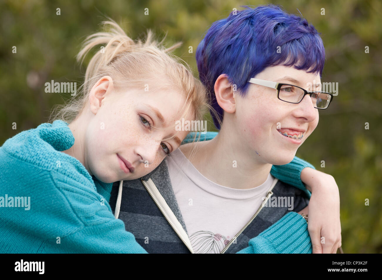 Blonde teenage girl and bright blue haired teenage girl hugging Stock ...